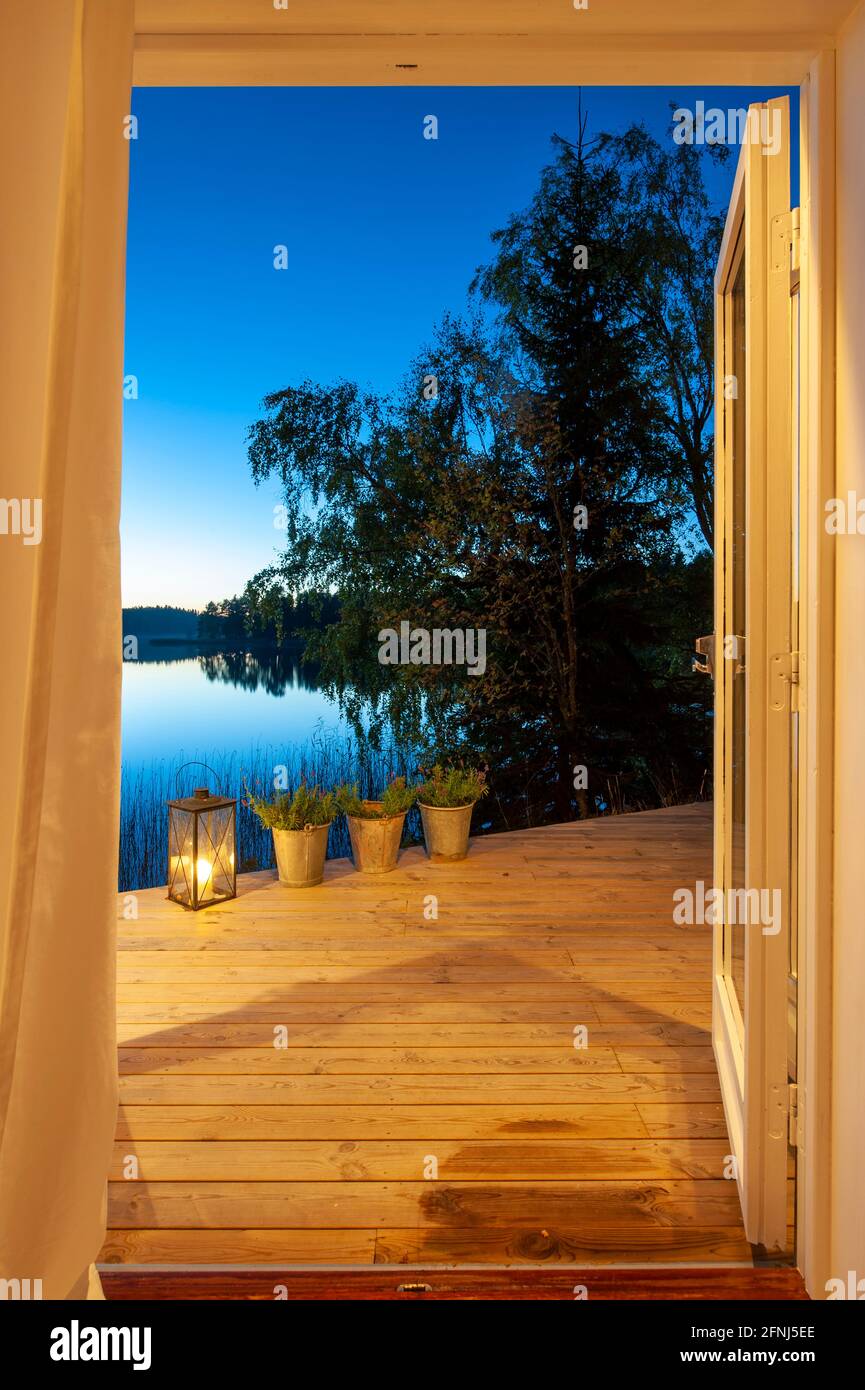 Evening lake-view through the opened door of a beach-house Stock Photo ...