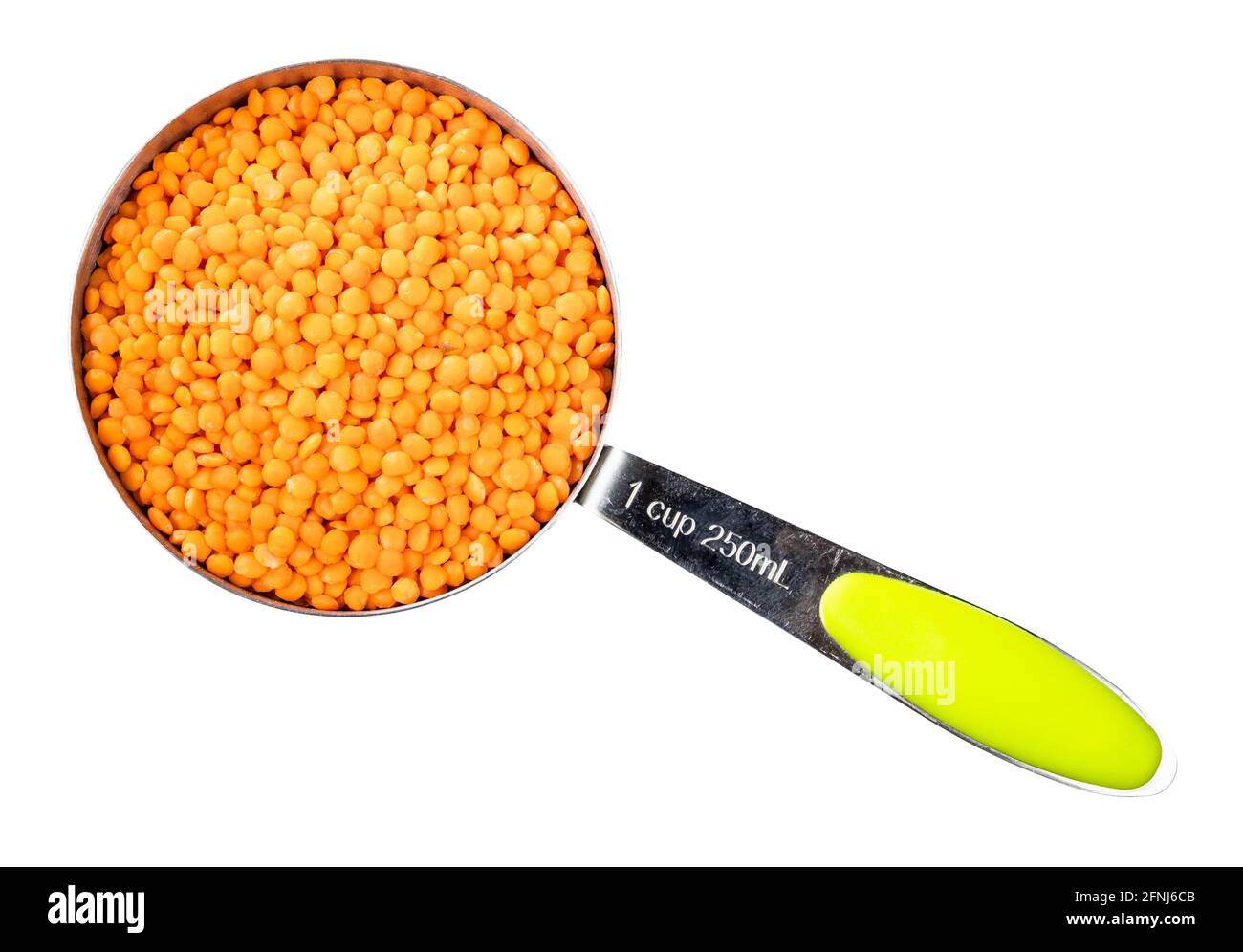 top view of whole red lentils in measuring cup cutout on white ...