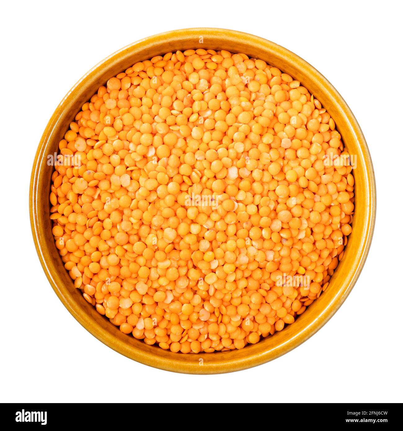 top view of hulled red lentils in round bowl cutout on white background ...
