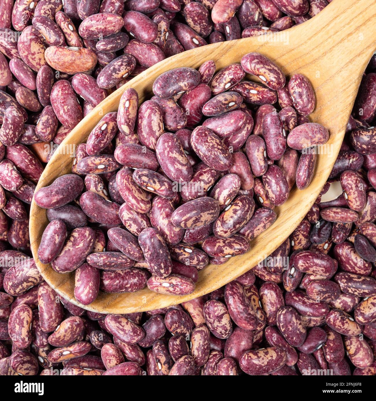 top view of red spotted pinto beans in wooden spoon closeup Stock Photo ...