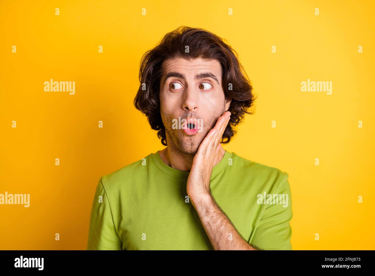 Photo of funny surprised guy hand cheek look side empty space wear ...