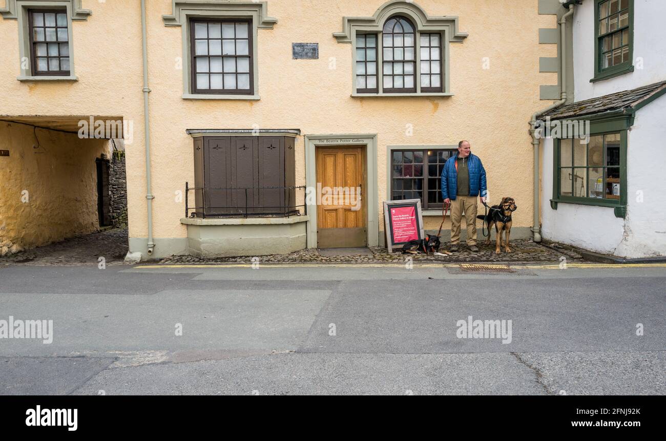 Male with his two pet dog waiting outside the closed Beatrix Potter ...