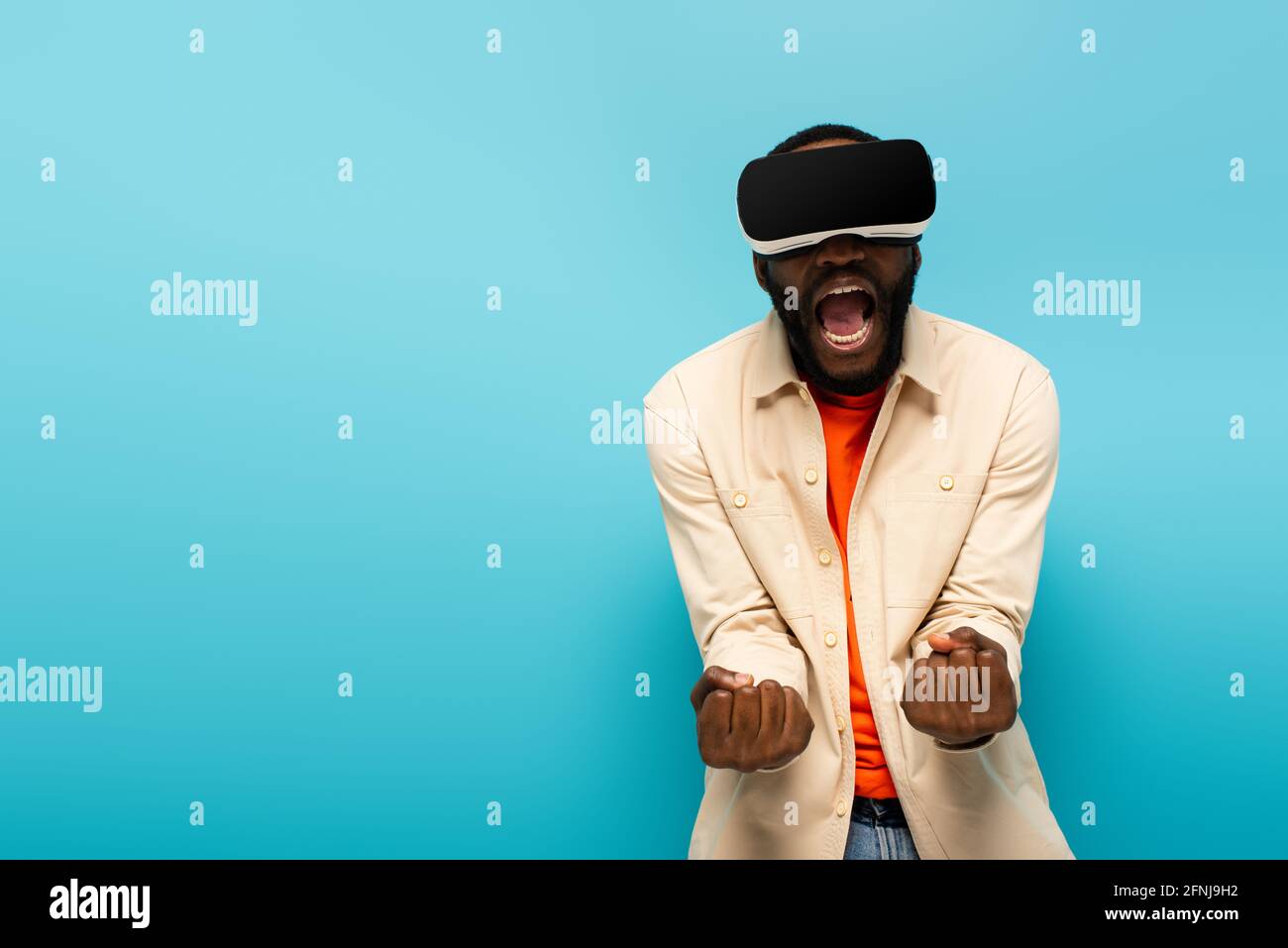 angry african american man in vr headset screaming and showing clenched ...