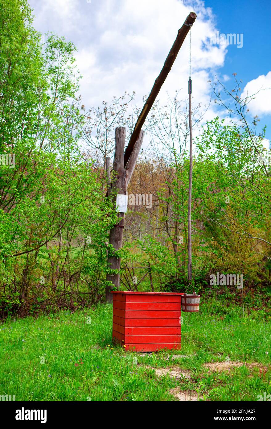 Wooden water well construction in old style . Rustic outdoor old well ...