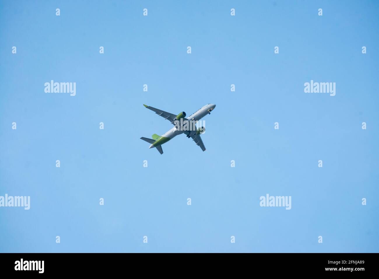 A plane in the blue sky Stock Photo - Alamy