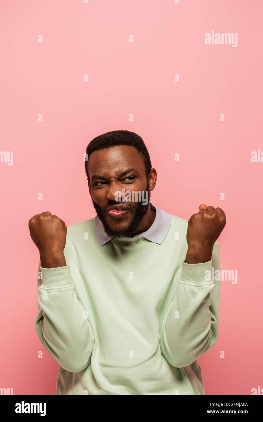 Excited african american man showing yes gesture isolated on pink Stock ...