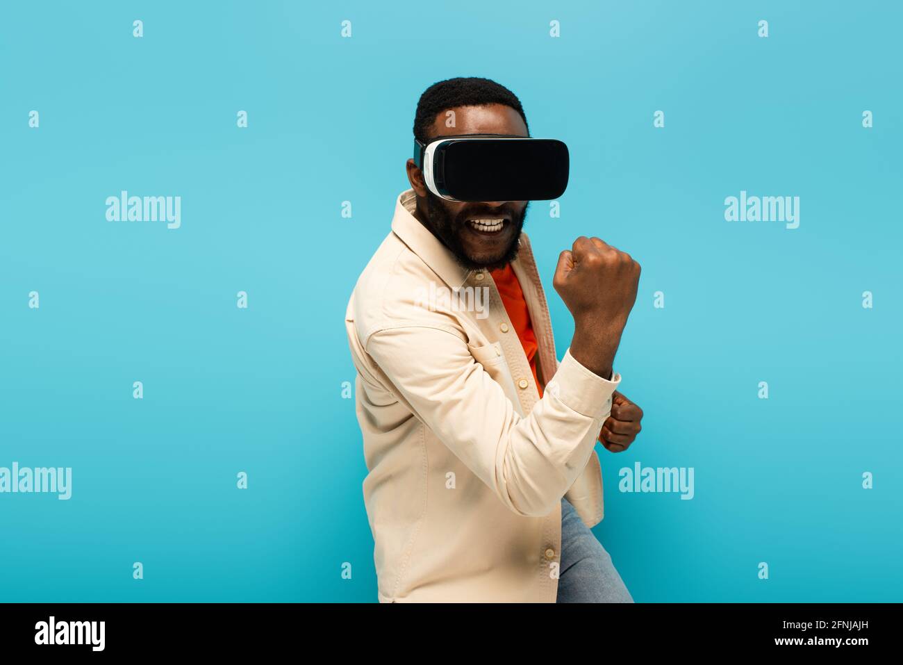 angry african american man showing clenched fists while gaming in vr ...