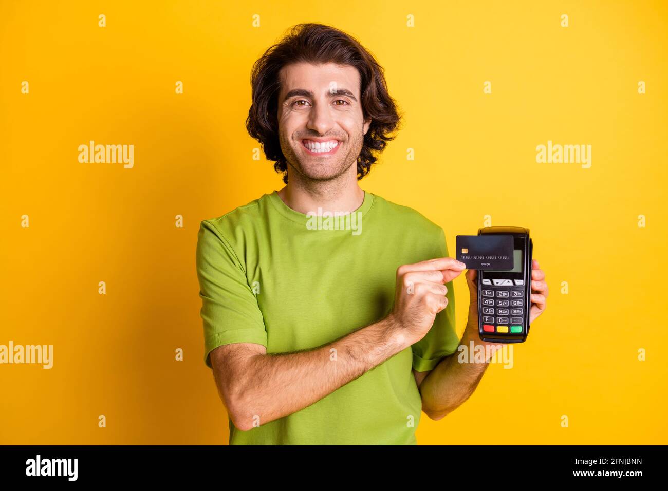 Portrait photo of smiling man paying doing purchase with bank card ...