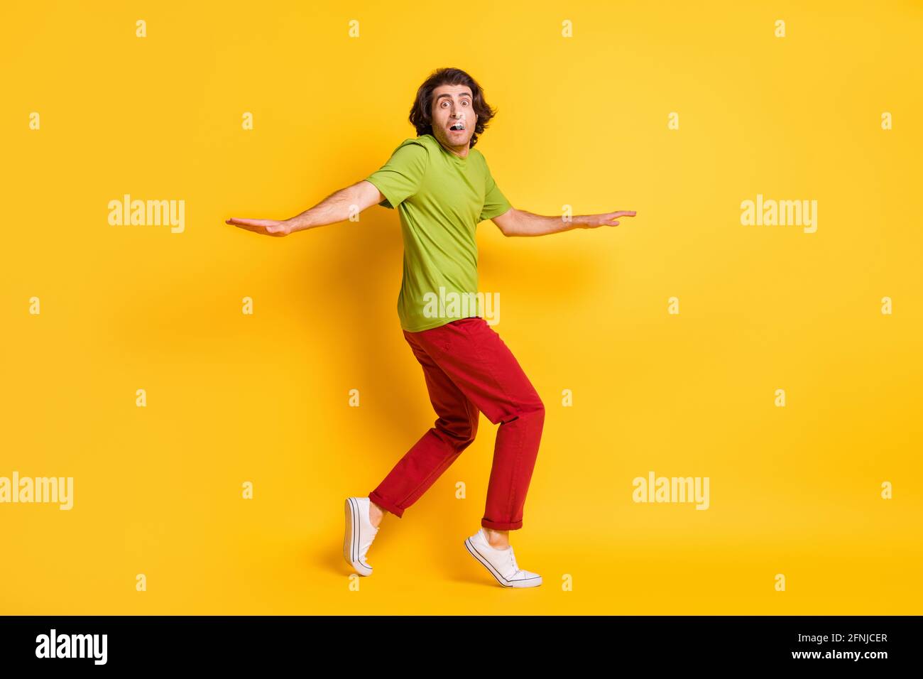 Full length body size photo of man going tiptoes looking nervous afraid ...