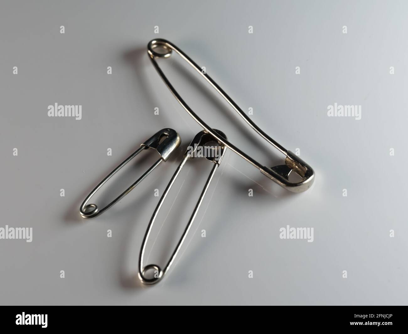 Three safety pins hi-res stock photography and images - Alamy