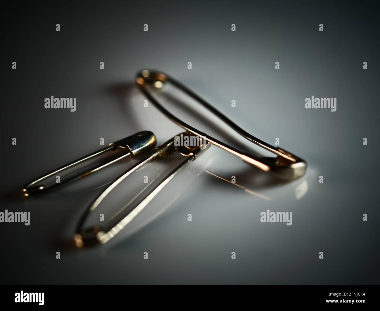 Three safety pins hi-res stock photography and images - Alamy