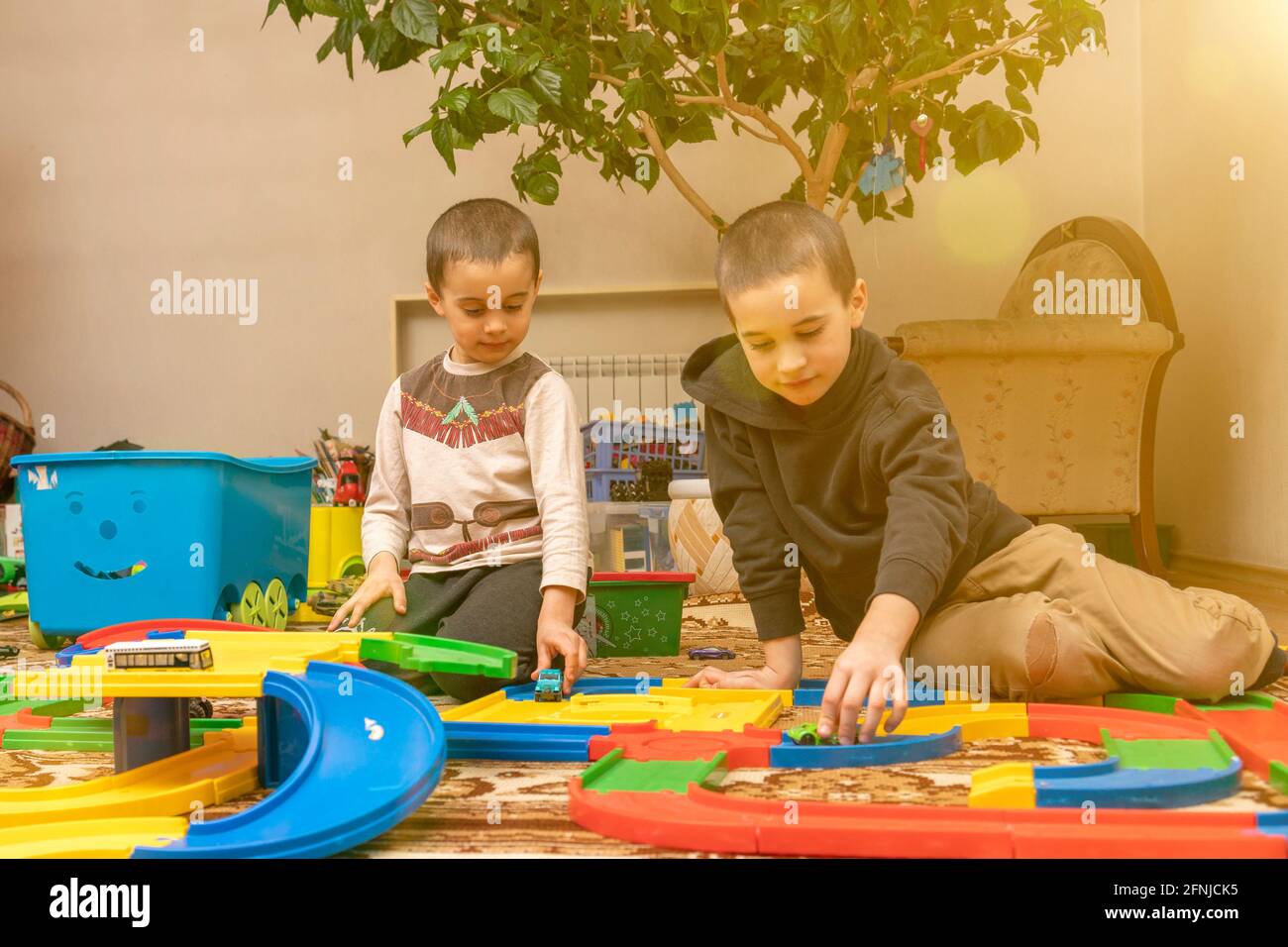 Children Boys playing with construction set on the floor.Educational ...
