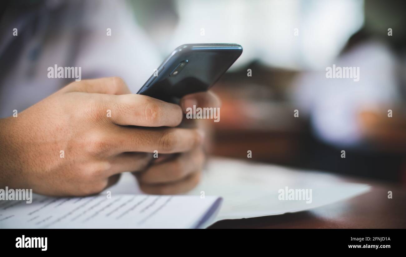 Students are test exam and study online by using smartphone in ...