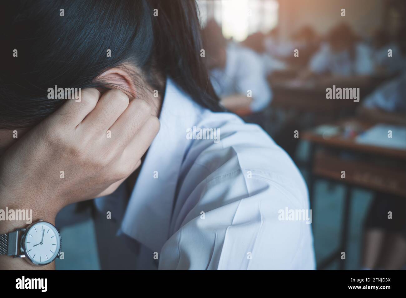 Anxious Student Sitting Examination In classroom with stress Stock Photo - Alamy