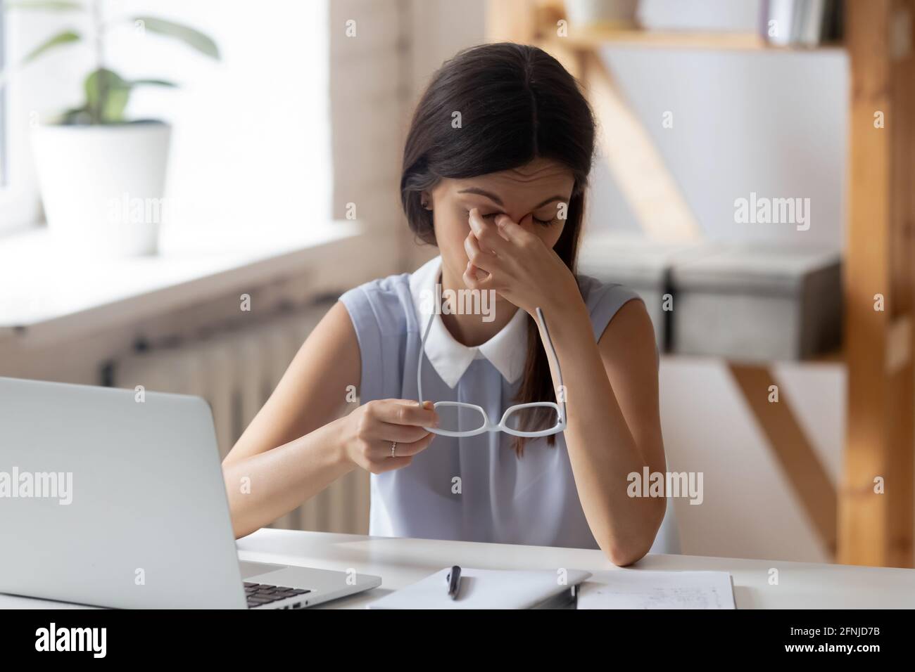 Tired millennial female suffer from dizziness in office Stock Photo - Alamy