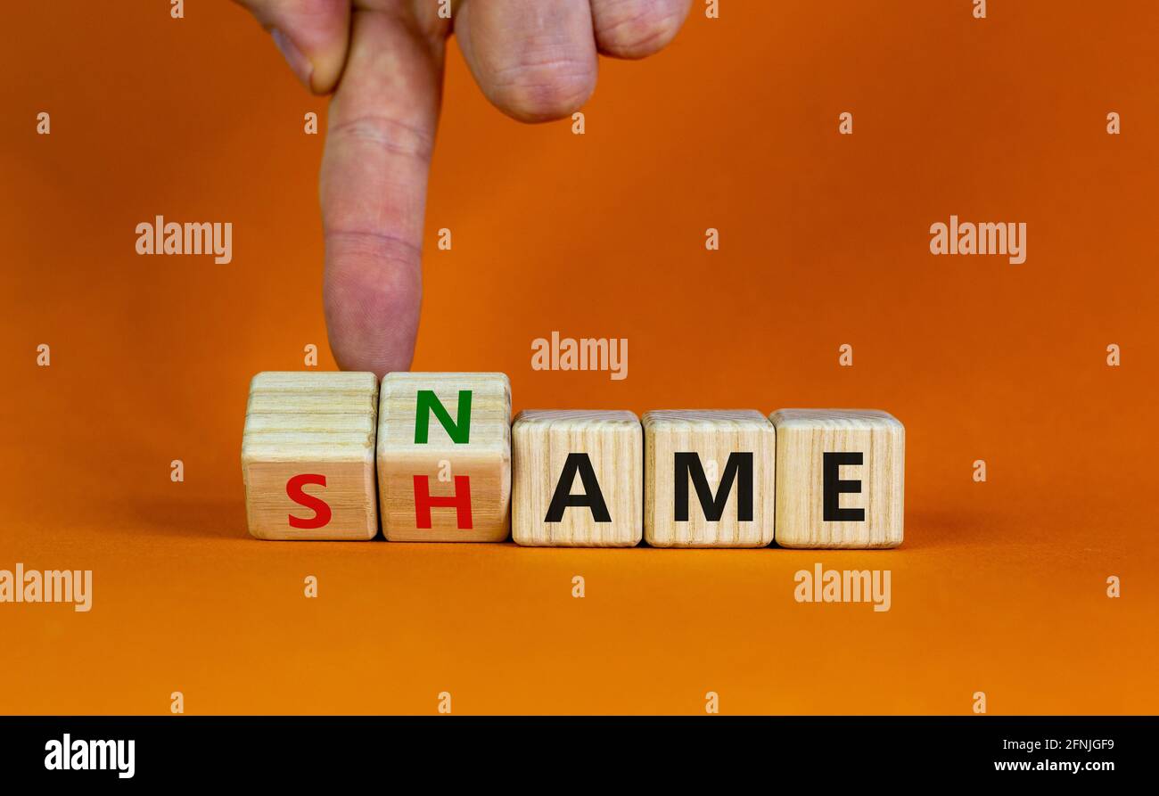Name or shame symbol. Businessman turns wooden cubes and changes the ...