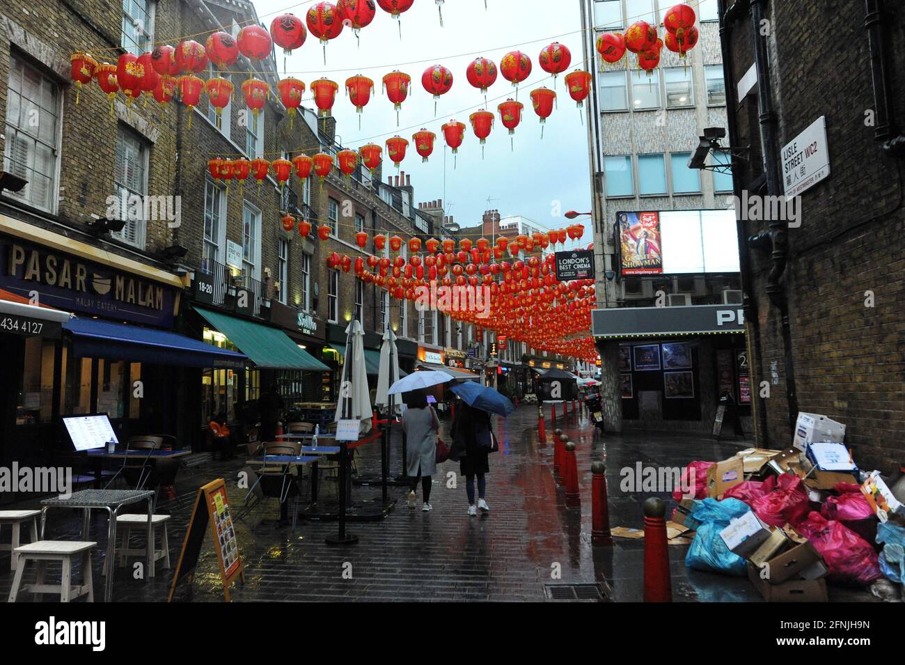 London, UK. 17th May, 2021. Lisle street in China Town. Heavy rain ...