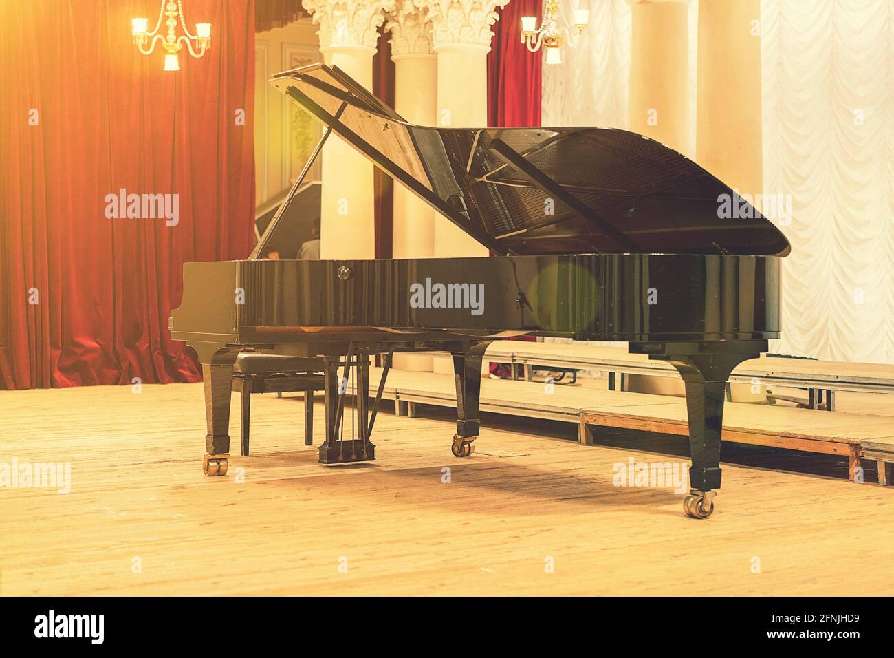 Grand Piano in Concert Hall. Piano standing on empty stage. opened ...