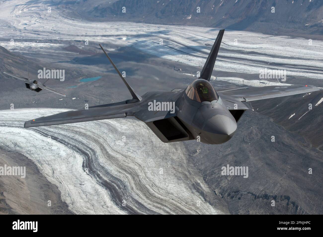 U.S. Air Force F-22 Raptor stealth fighter jets, fly in formation over ...