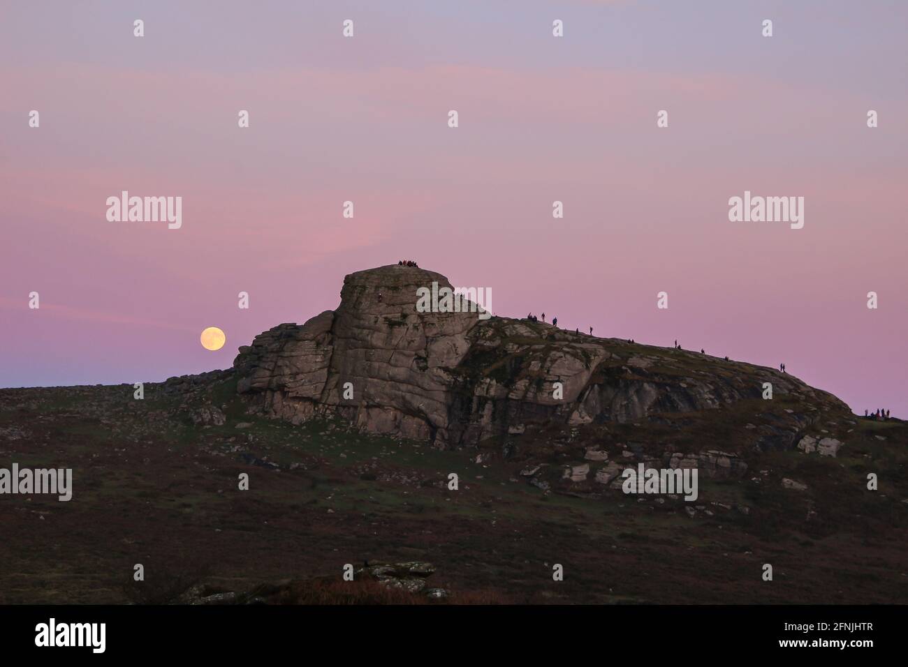 The full moon rises over Haytor Rocks, on Dartmoor at sunset Stock ...