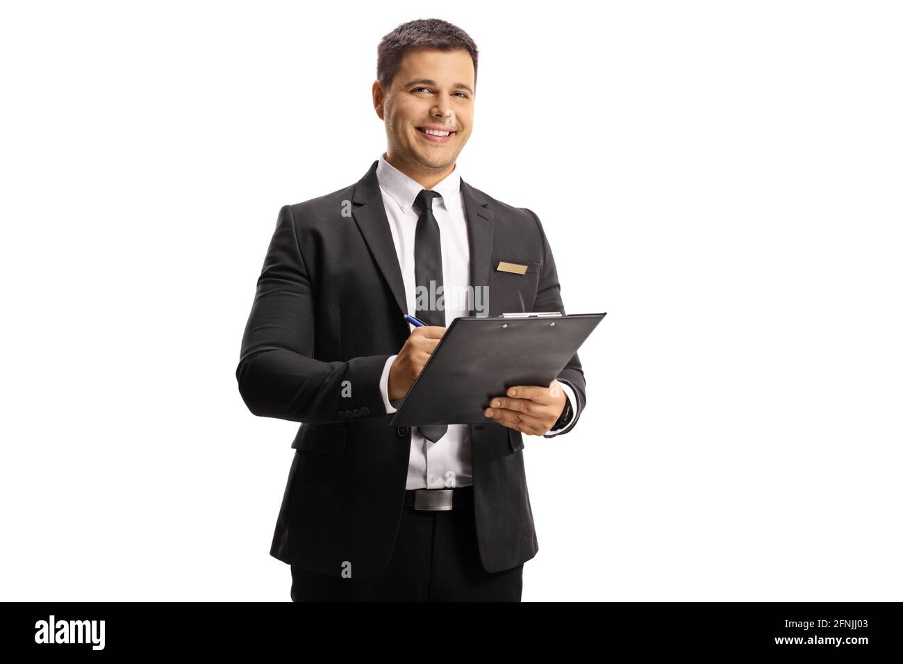 Young elegant man with a name tag on his suit holding a clipboard ...