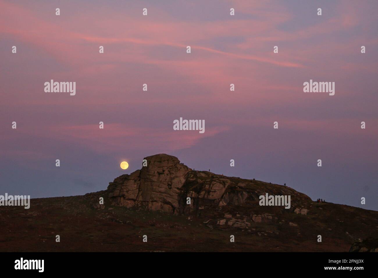 The full moon rises over Haytor Rocks, on Dartmoor at sunset Stock ...