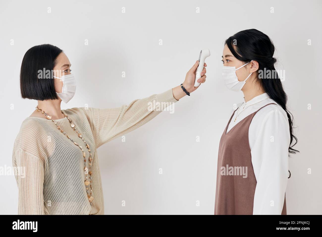 Checking body temperature in the office Stock Photo - Alamy