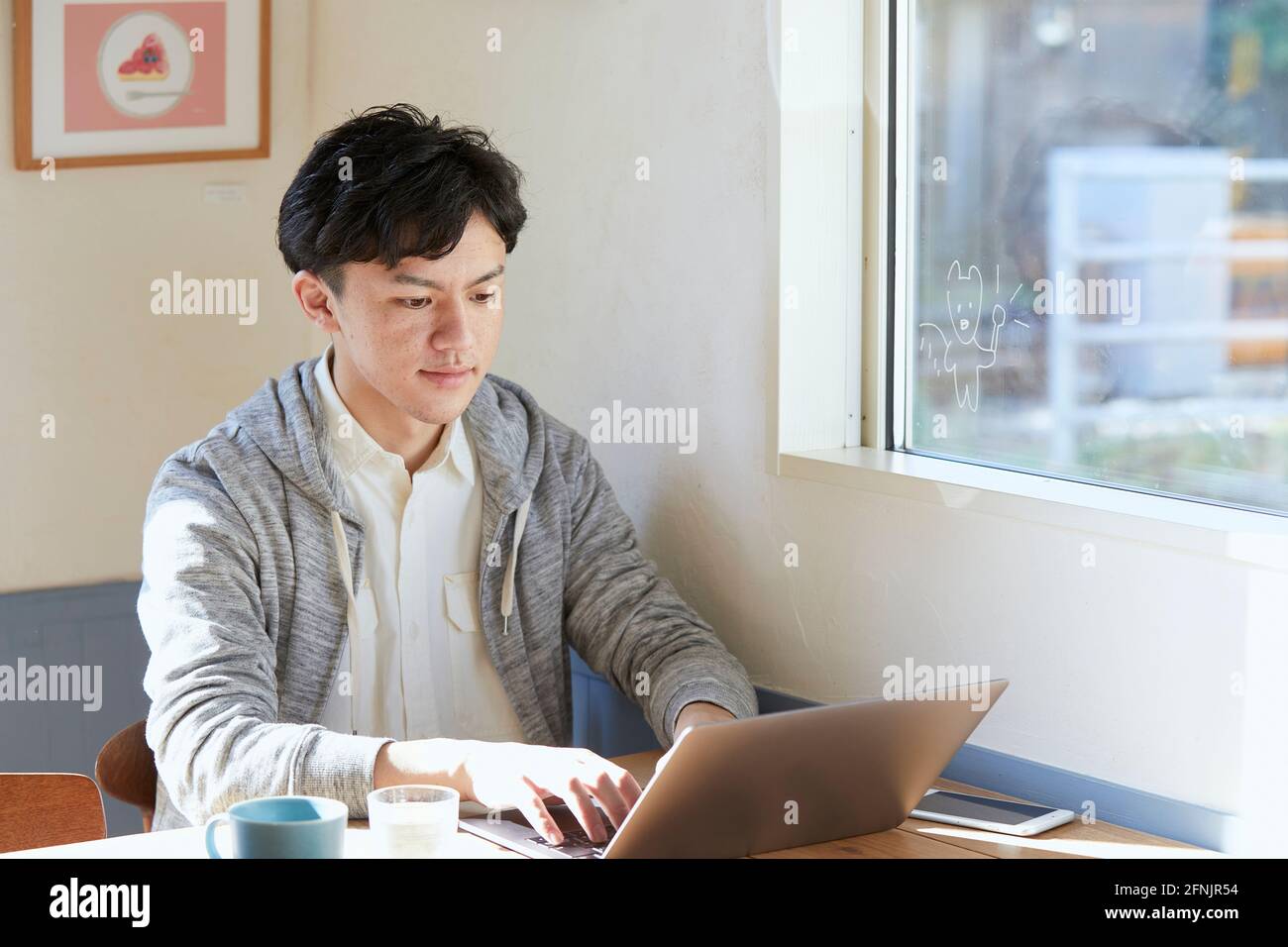 Young Japanese man at a cafe Stock Photo - Alamy