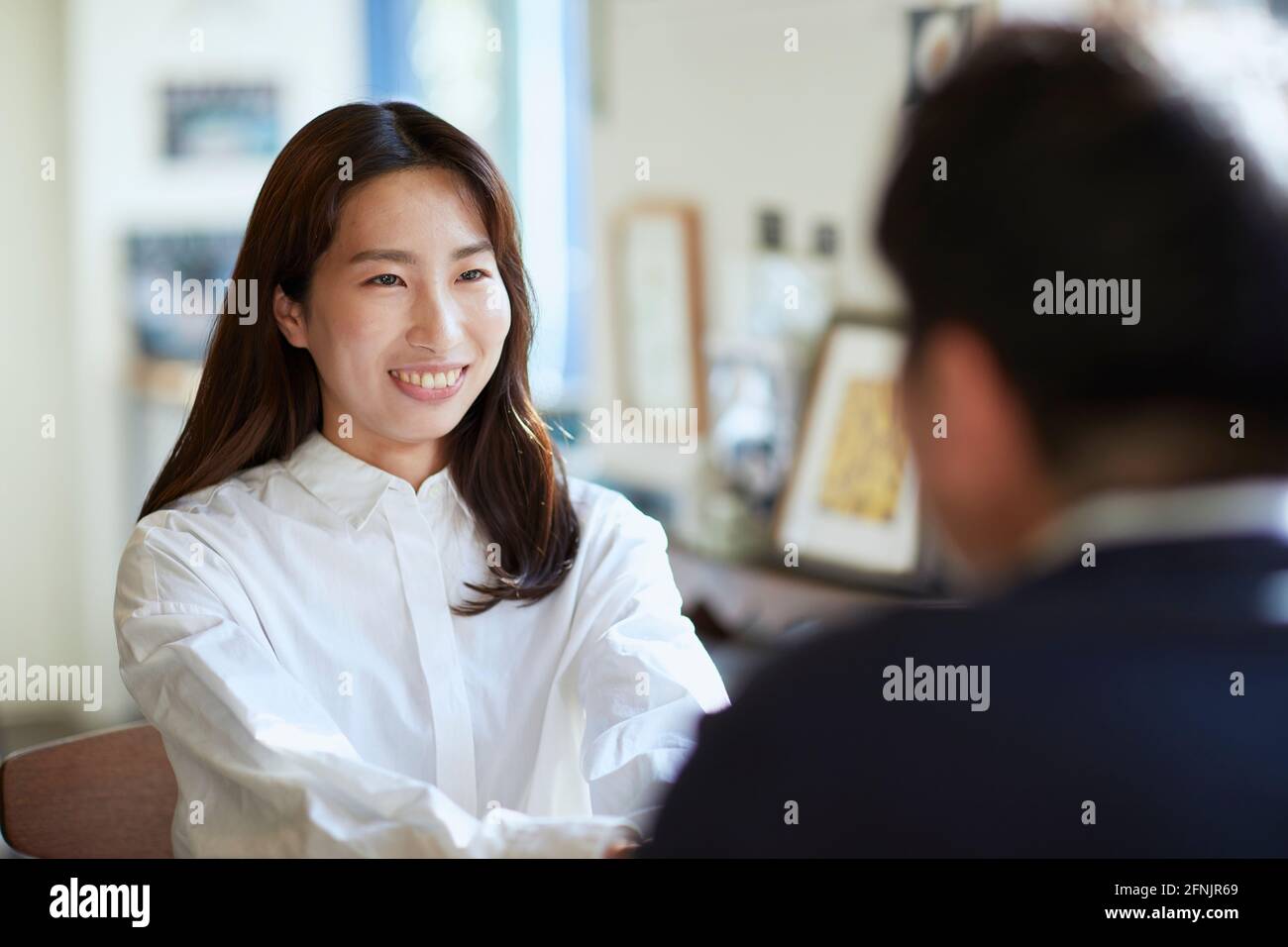 Young Japanese couple at a cafe Stock Photo - Alamy