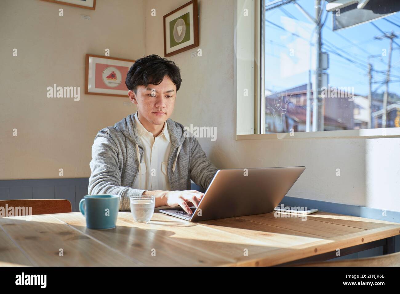 Young Japanese man at a cafe Stock Photo - Alamy