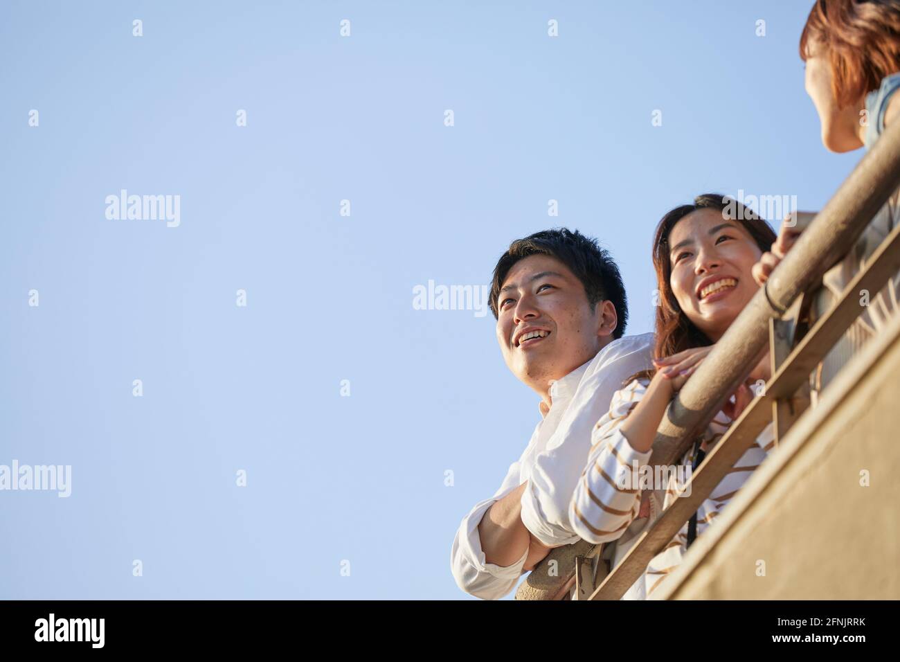 Young Japanese friends at a city park Stock Photo - Alamy