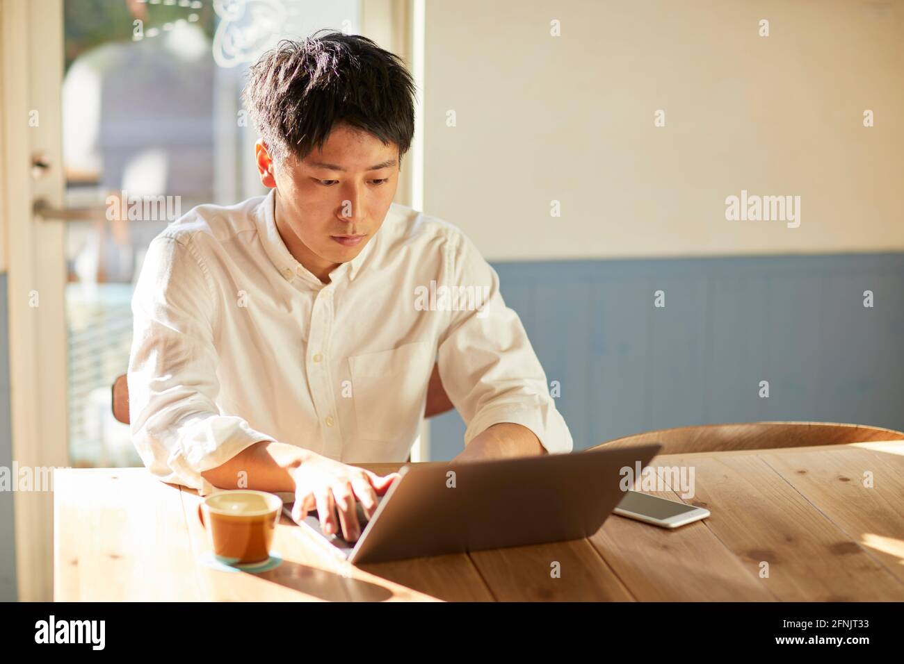 Young Japanese man at a cafe Stock Photo - Alamy