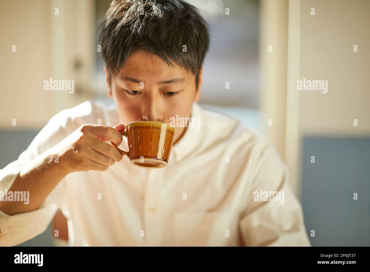 Young Japanese man at a cafe Stock Photo - Alamy