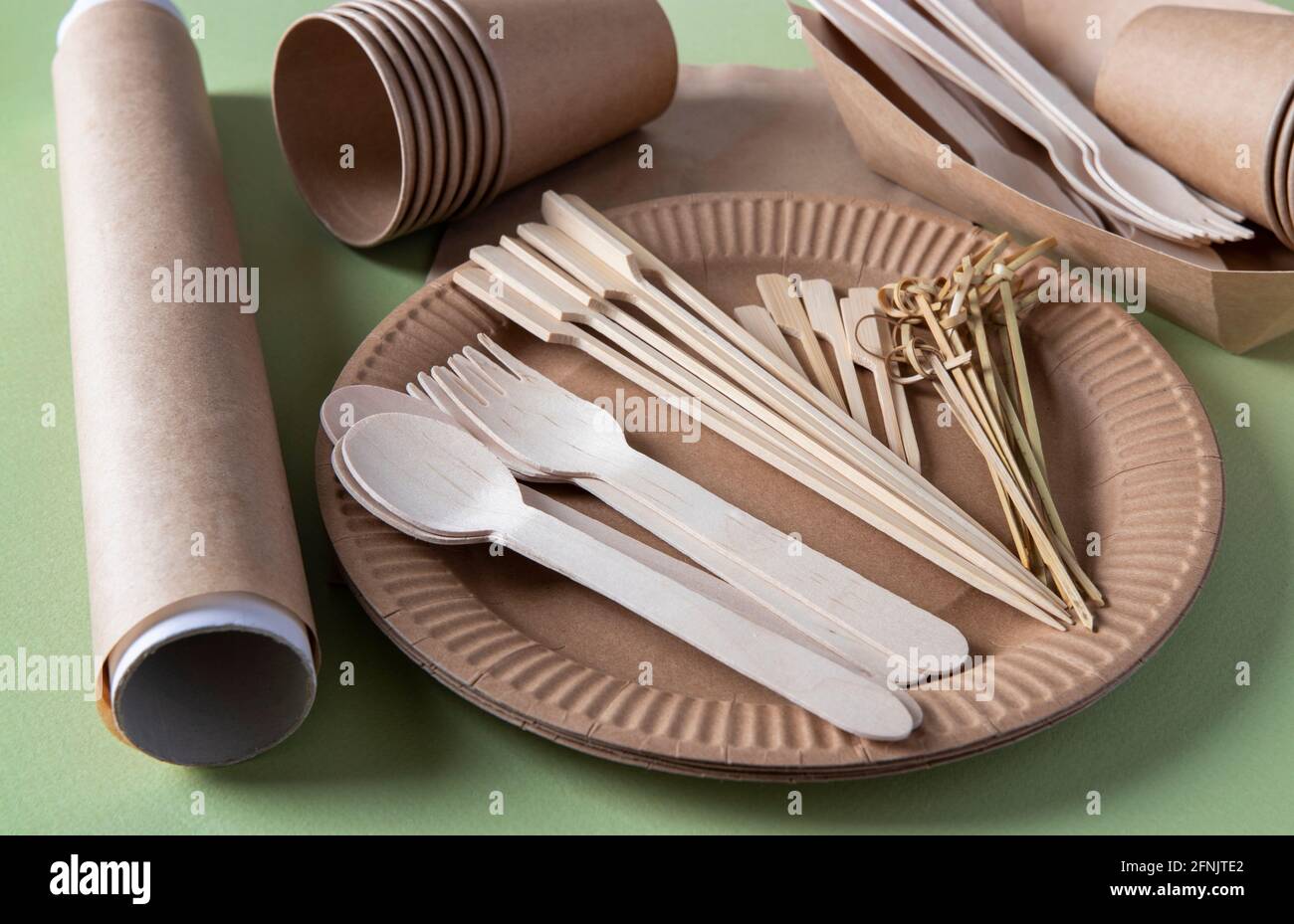 Disposable biodegradable tableware on craft paper plate - forks, spoons ...