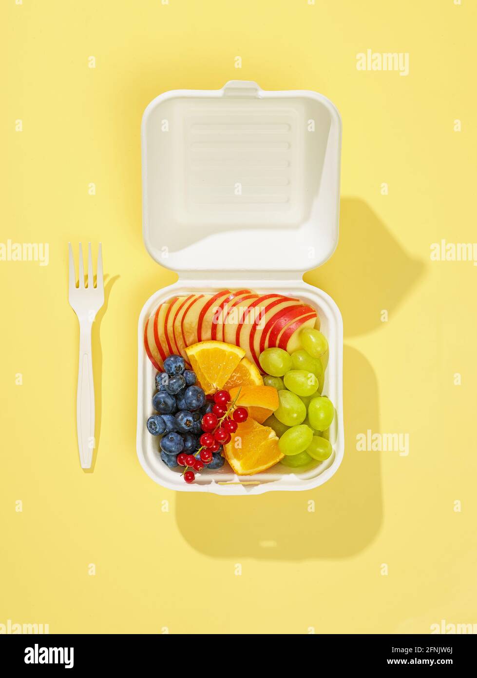 fresh sliced fruit and berries in white take away box isolated on ...