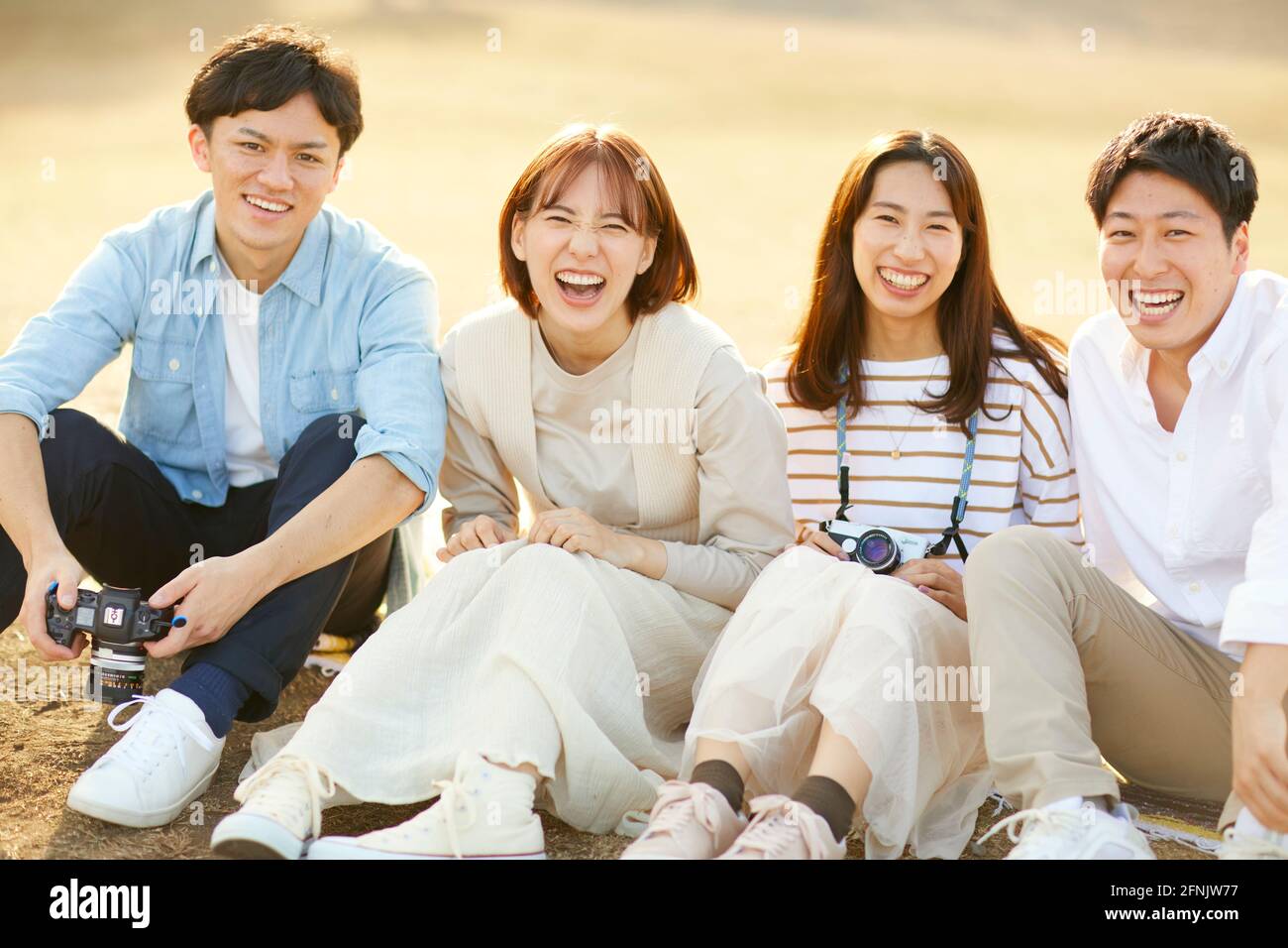Young Japanese friends at a city park Stock Photo - Alamy