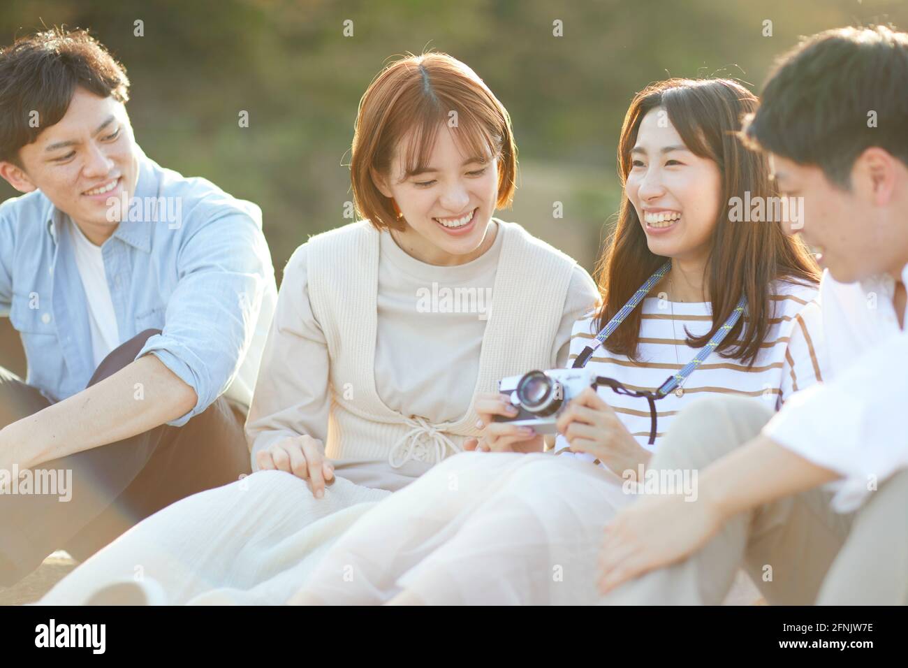 Young Japanese friends at a city park Stock Photo - Alamy