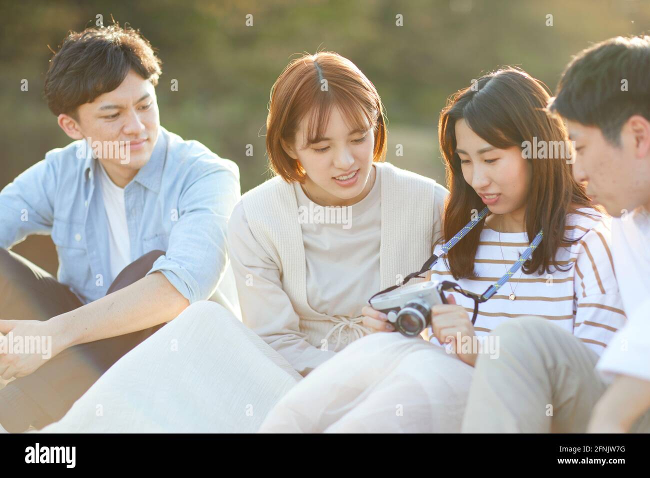 Young Japanese friends at a city park Stock Photo - Alamy