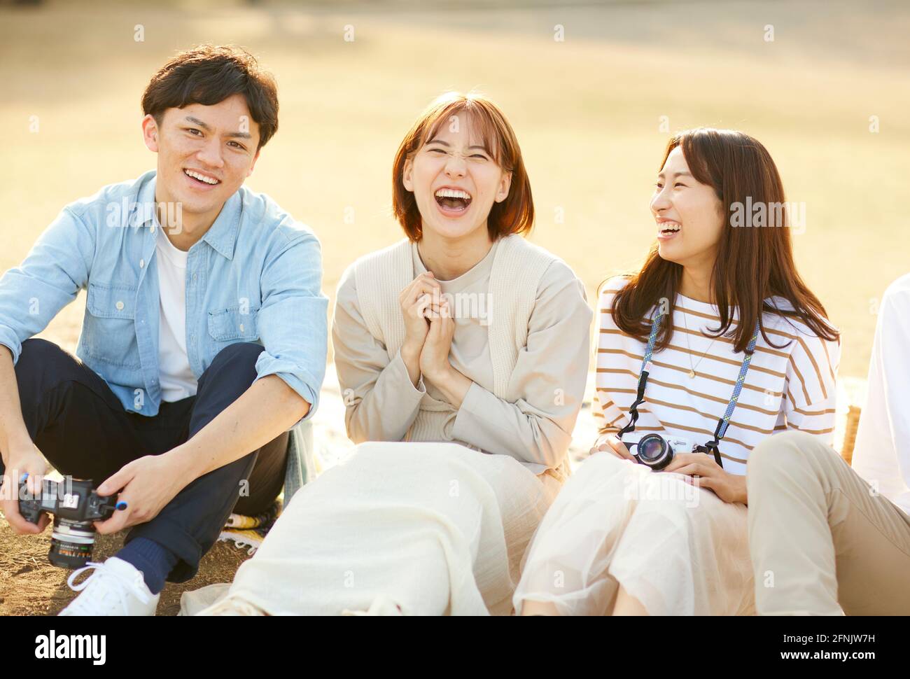 Young Japanese friends at a city park Stock Photo - Alamy
