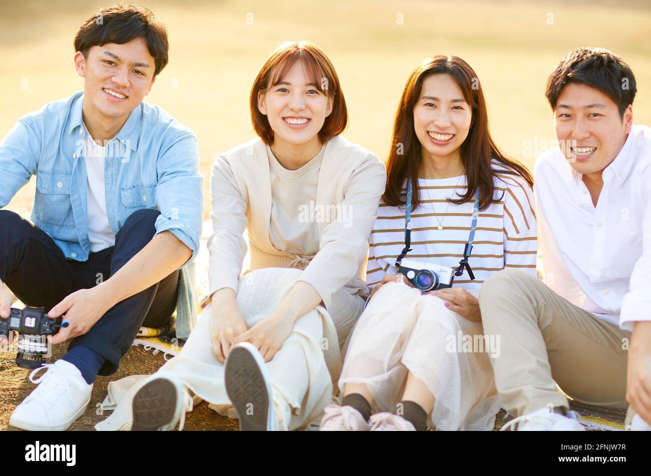 Young Japanese friends at a city park Stock Photo - Alamy