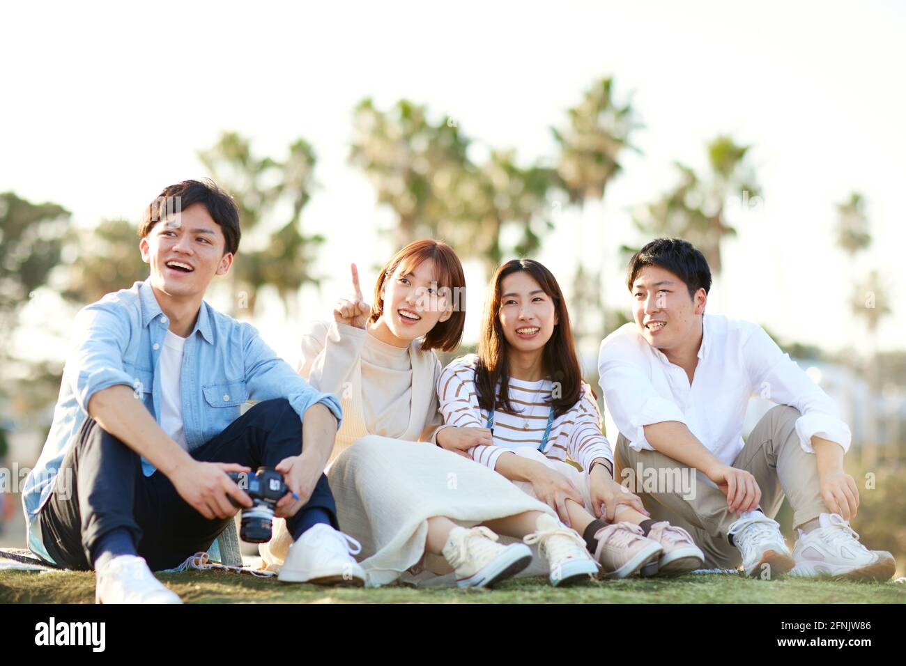 Young Japanese friends at a city park Stock Photo - Alamy