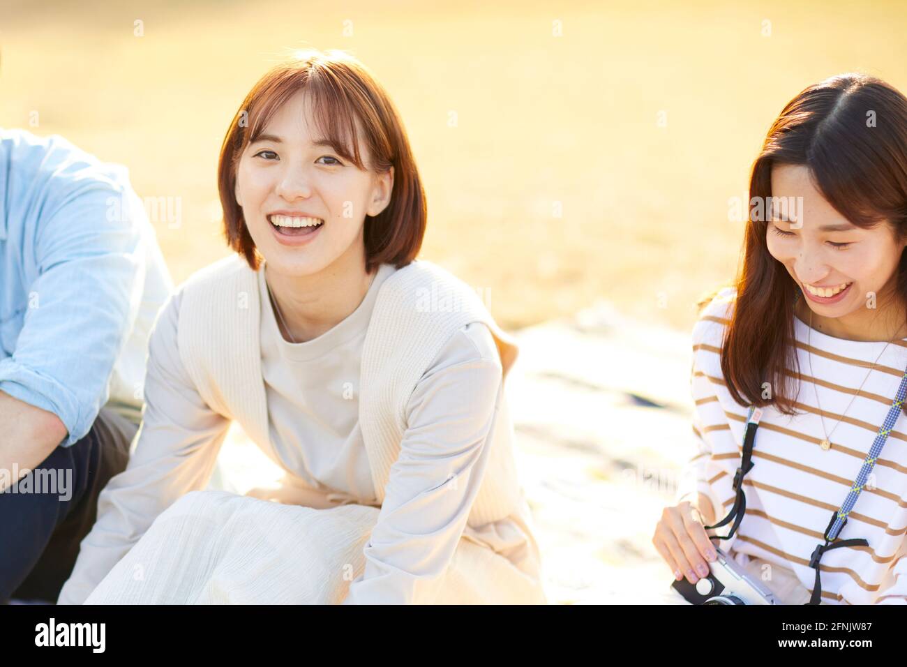 Young Japanese friends at a city park Stock Photo - Alamy