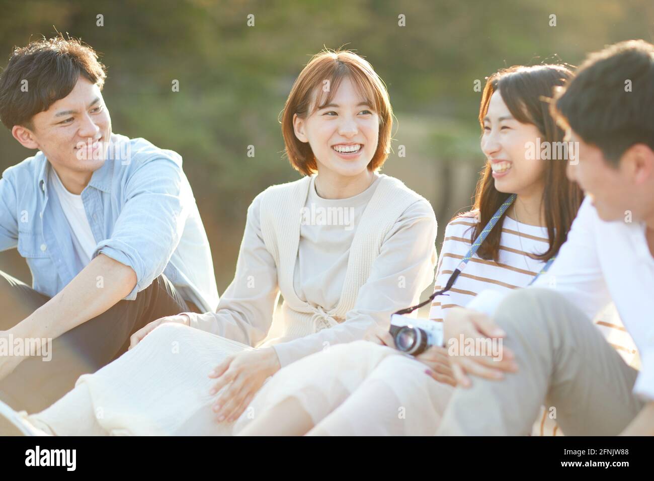 Young Japanese friends at a city park Stock Photo - Alamy
