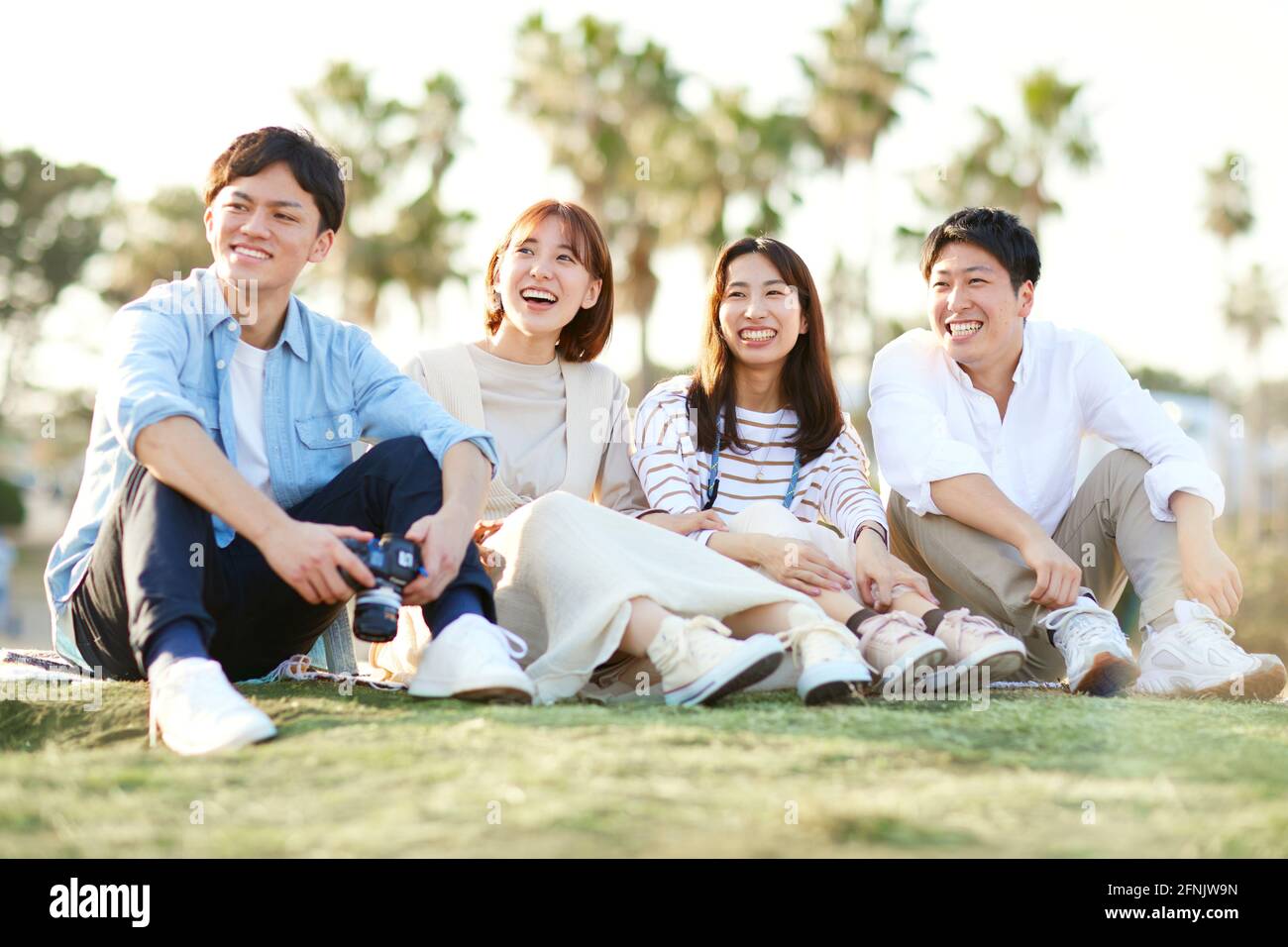 Young Japanese friends at a city park Stock Photo - Alamy