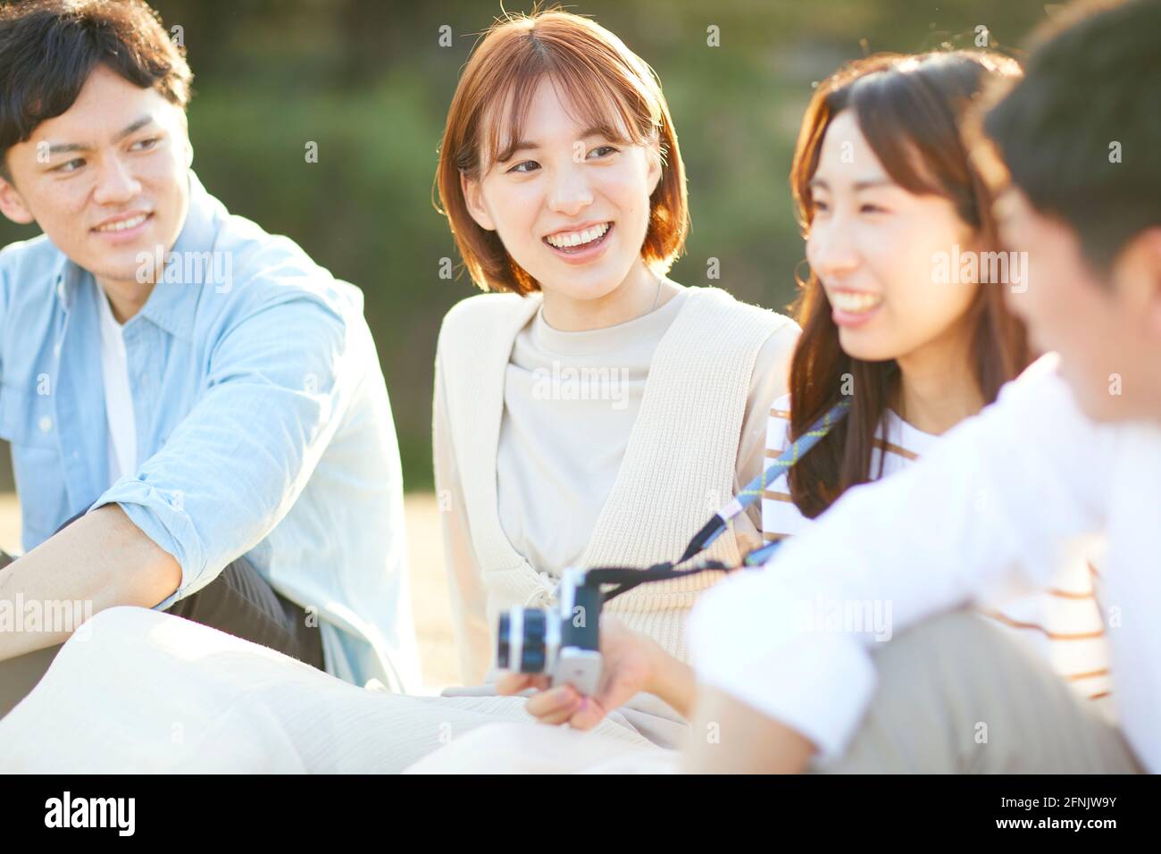 Young Japanese friends at a city park Stock Photo - Alamy