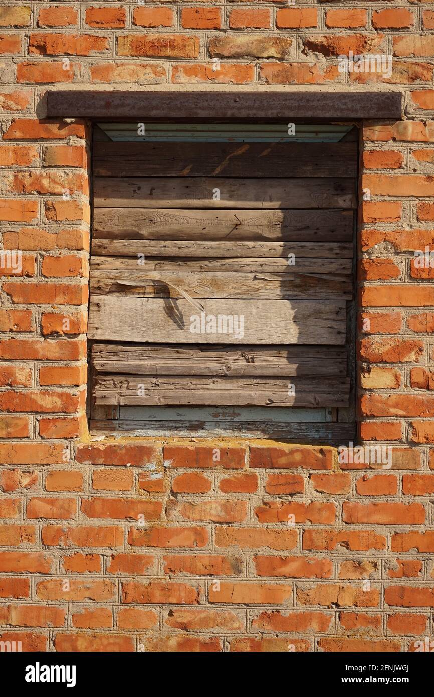 Closed with wooden planks window opening in an old red brick wall Stock ...