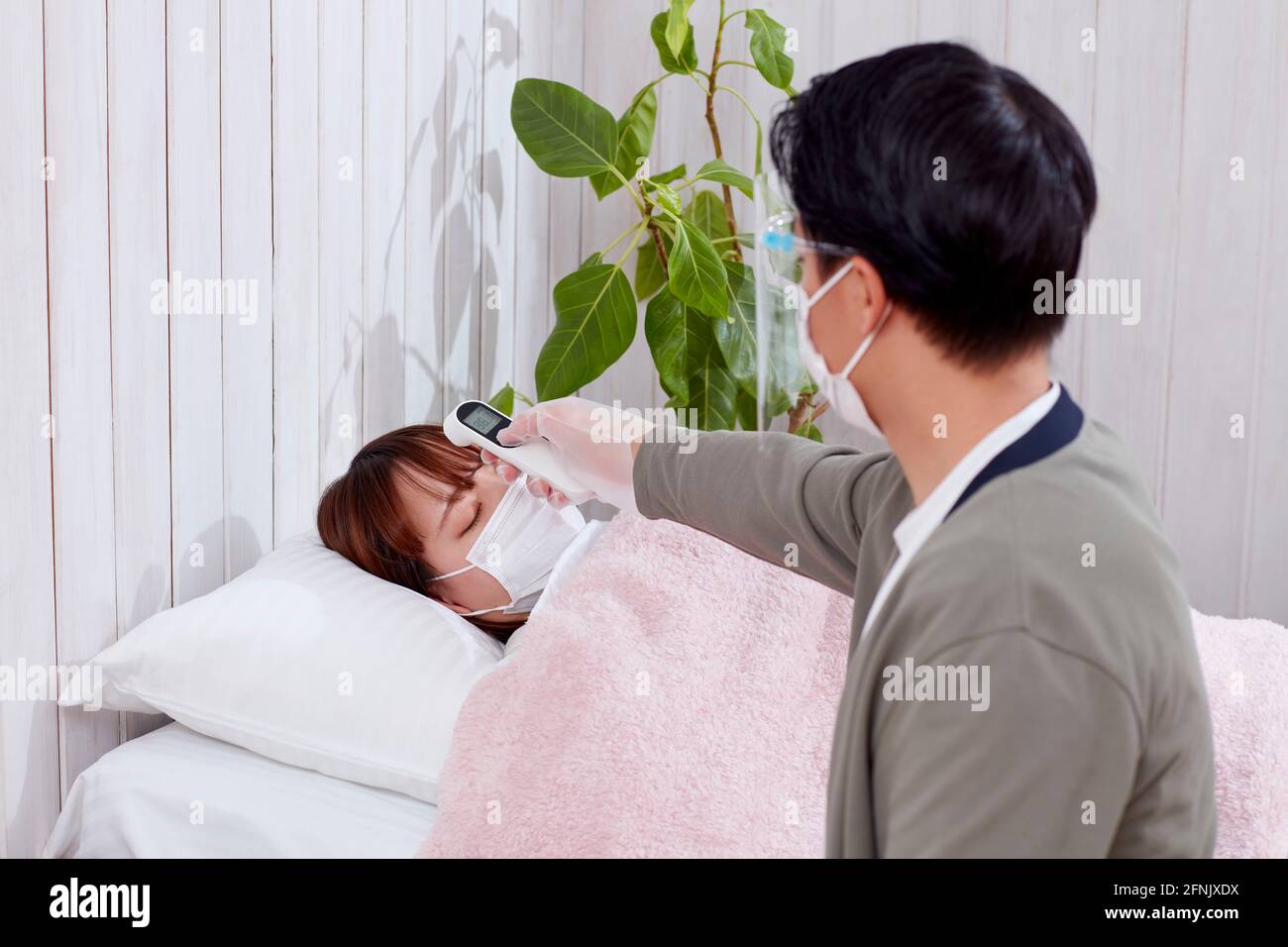 Japanese woman sick in bed Stock Photo - Alamy