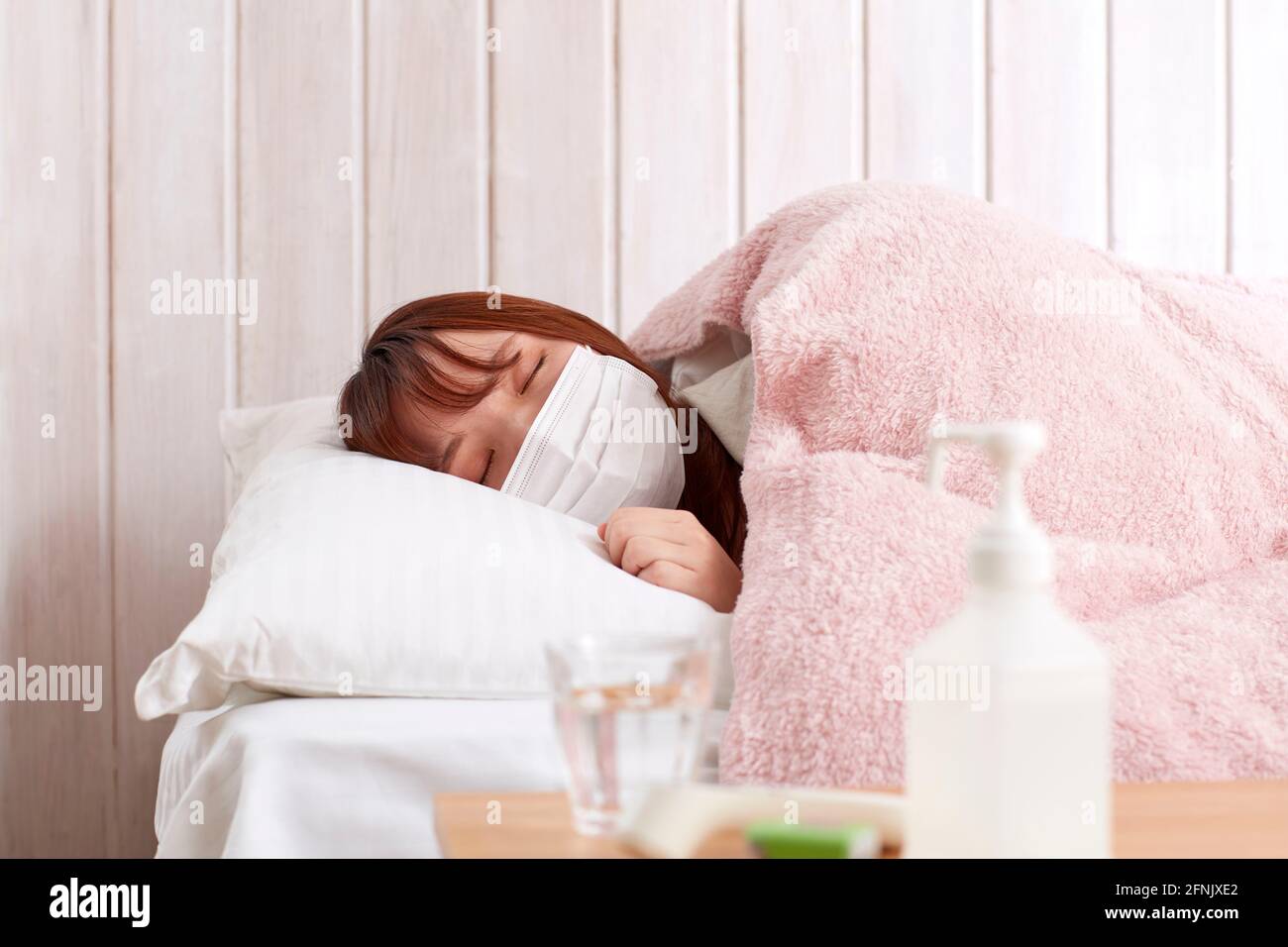 Japanese woman sick in bed Stock Photo - Alamy