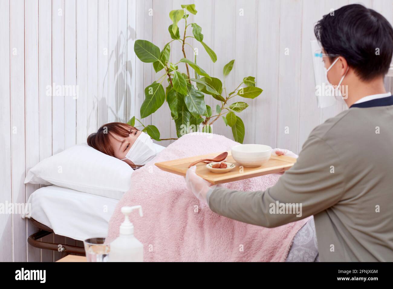 Japanese woman sick in bed Stock Photo - Alamy