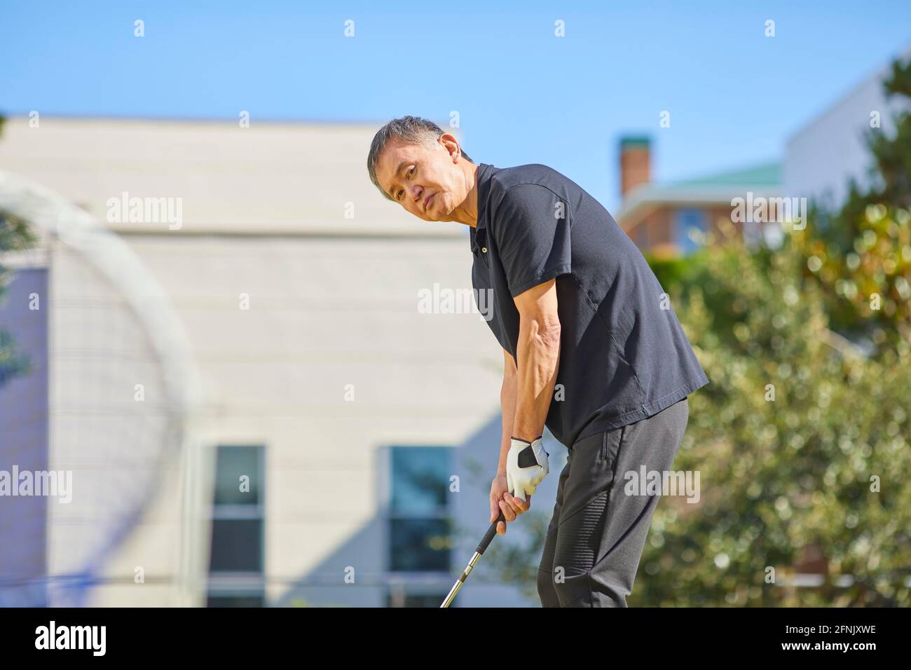 Asian man playing golf hi-res stock photography and images - Alamy